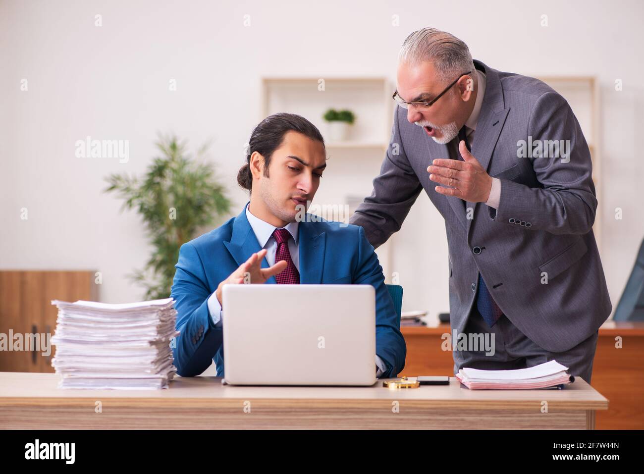 Two male employees working in the office Stock Photo - Alamy
