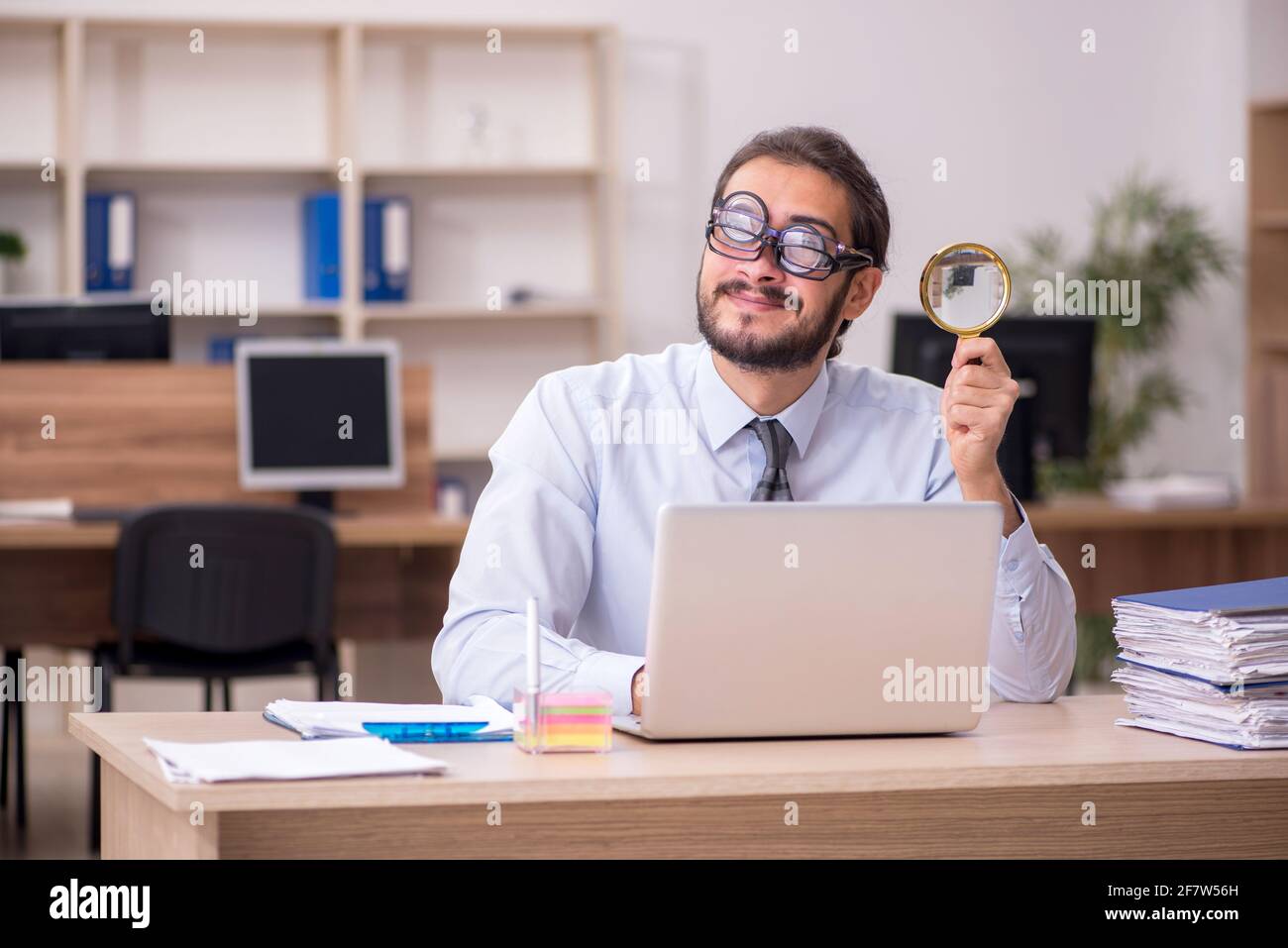 Office work funny young magnifying hi-res stock photography and images ...