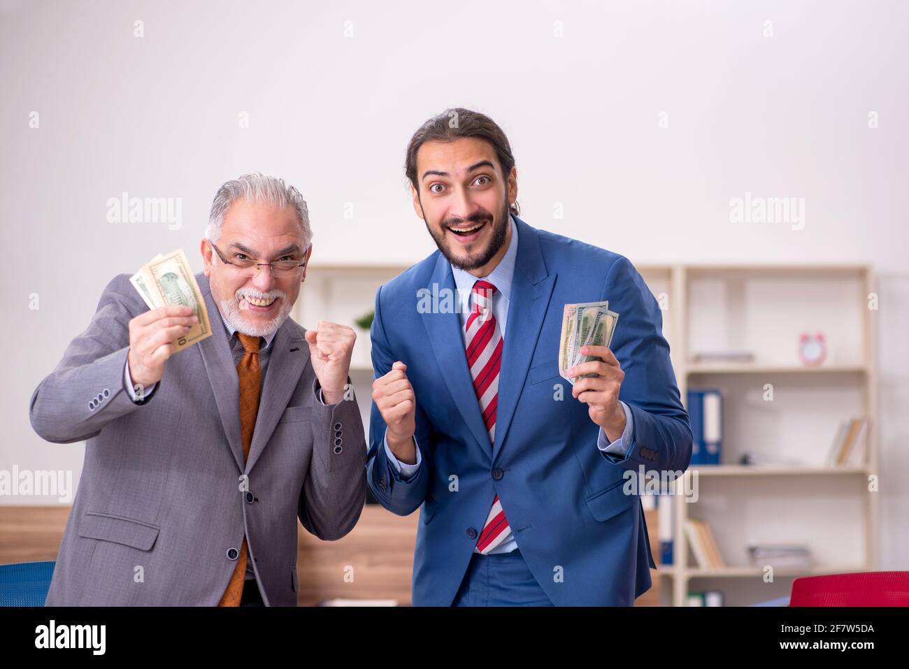 Two employees in remuneration concept Stock Photo - Alamy
