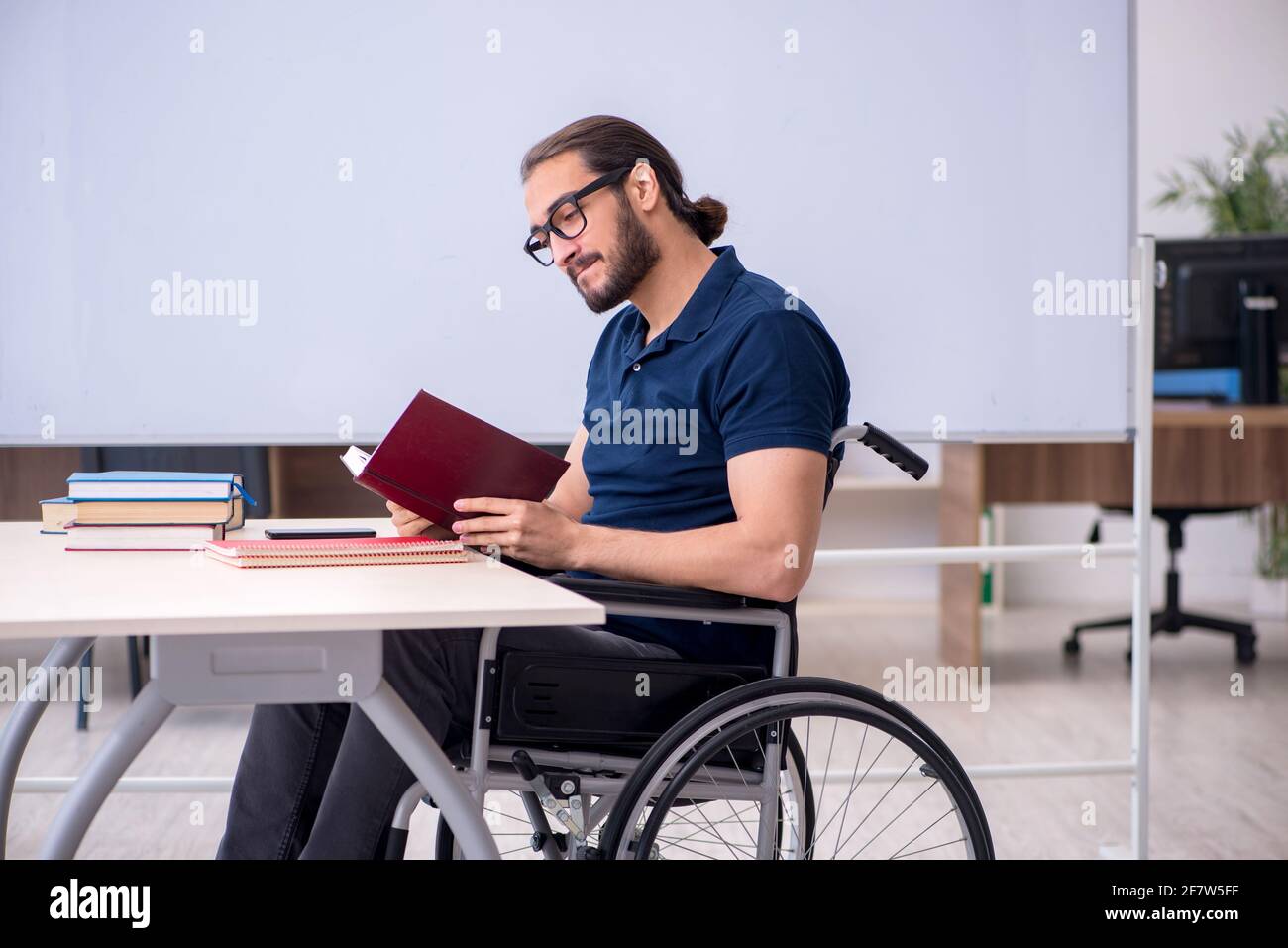 Young handicapped student in the classroom Stock Photo - Alamy