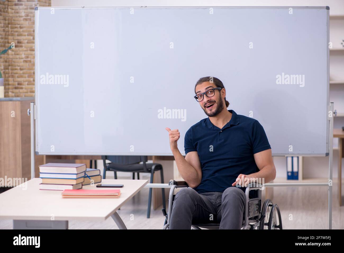 Young handicapped student in the classroom Stock Photo - Alamy