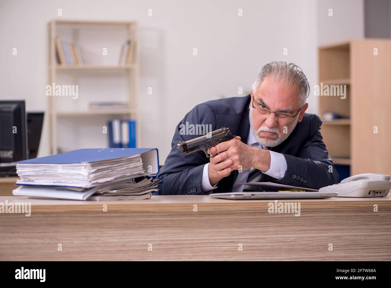 Angry businessman aiming gun hi-res stock photography and images - Alamy