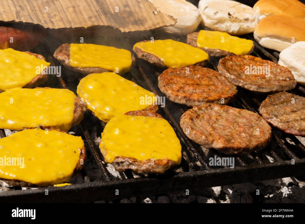 Closeup shot of fresh burger patties with cheese on the grill Stock ...