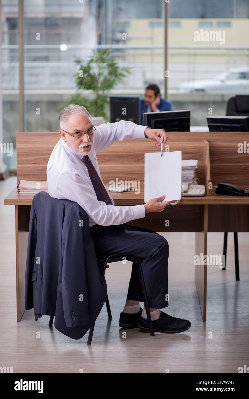 Two businessmen employees sitting in the office Stock Photo - Alamy
