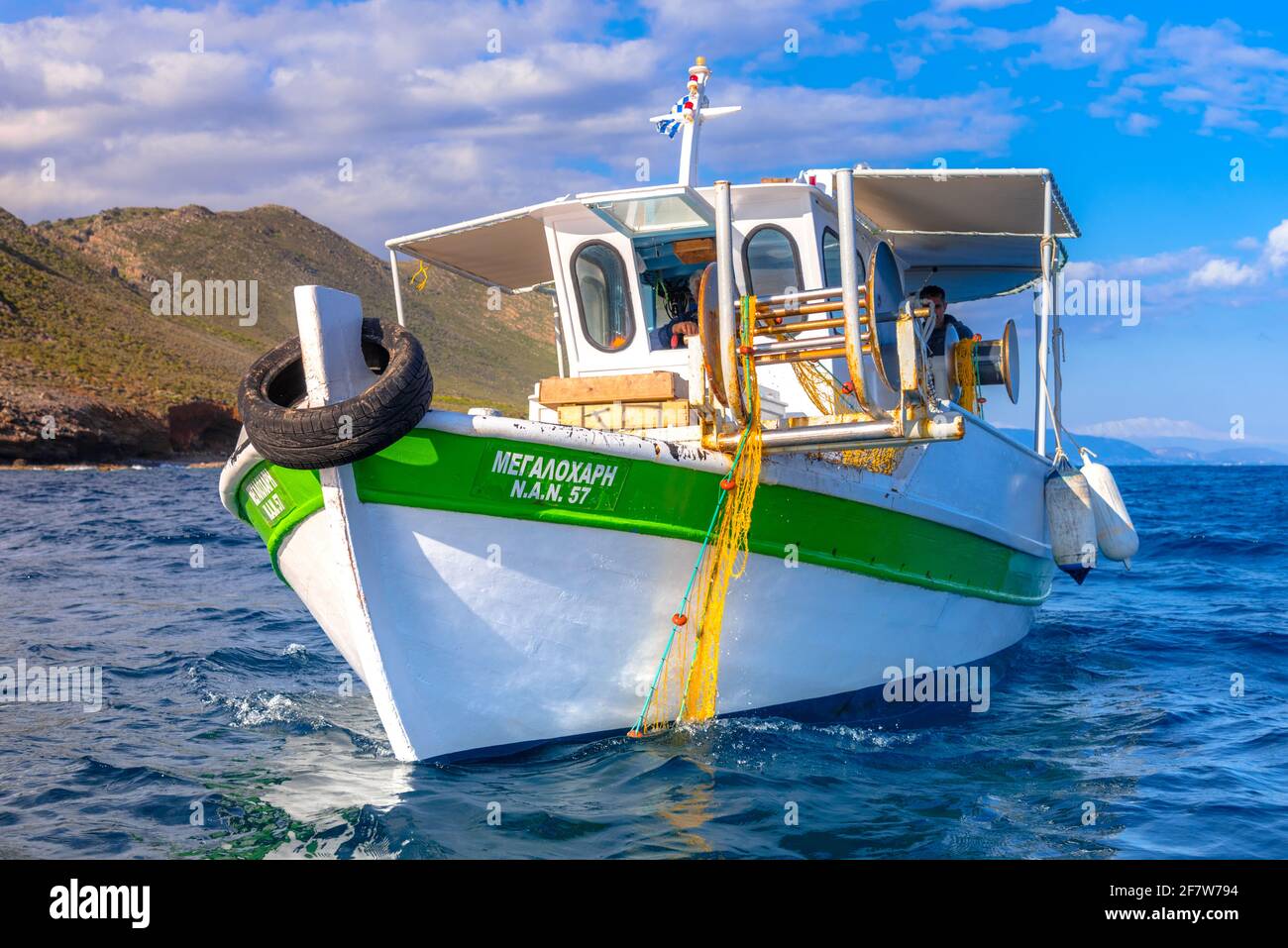 Fisherman is fishing fresh fishes using yellow fishing nets, on fishing ...
