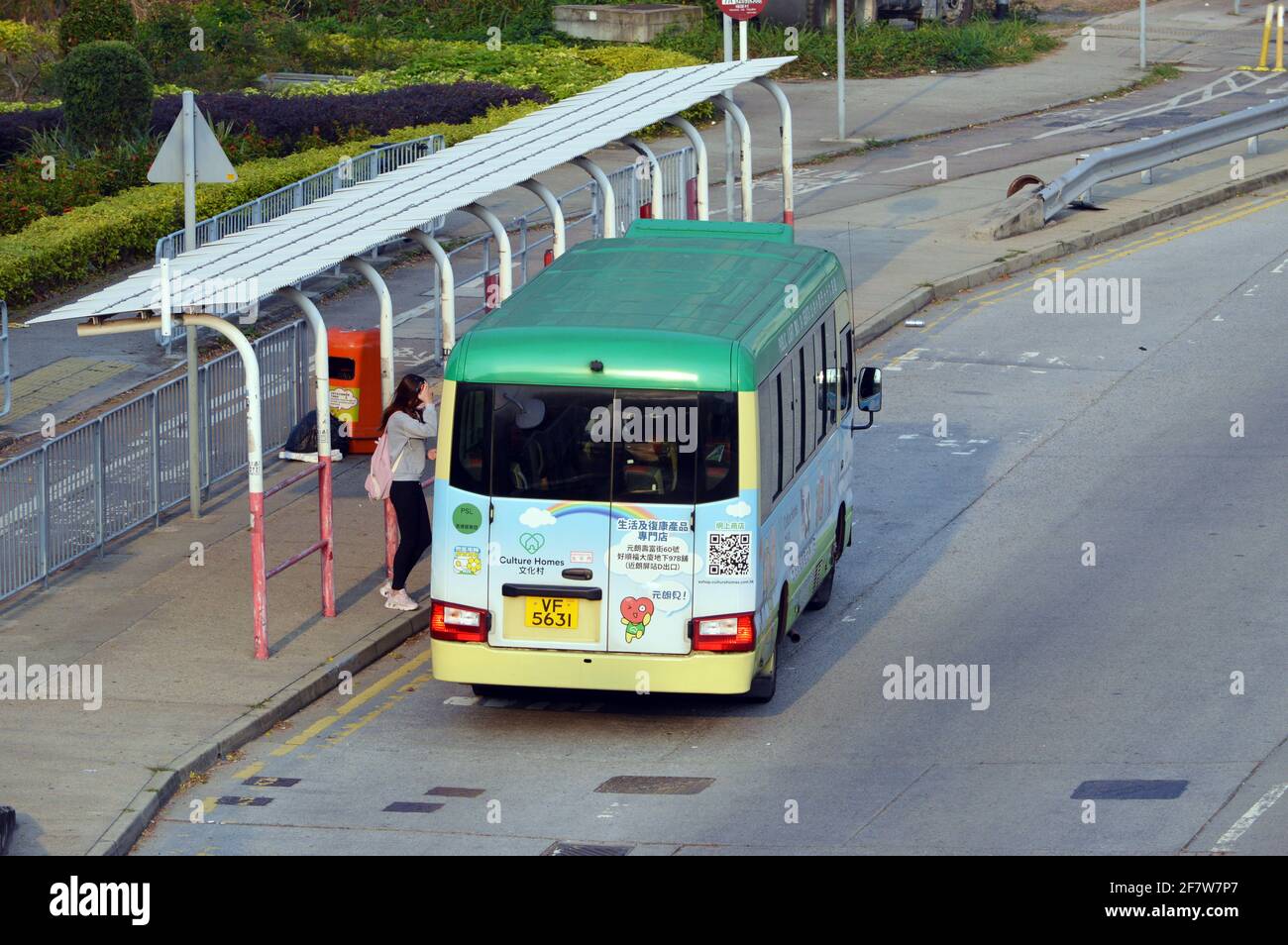 Passenger boarding a green minibus at Yeung Uk Tsuen bus stop, Yuen ...
