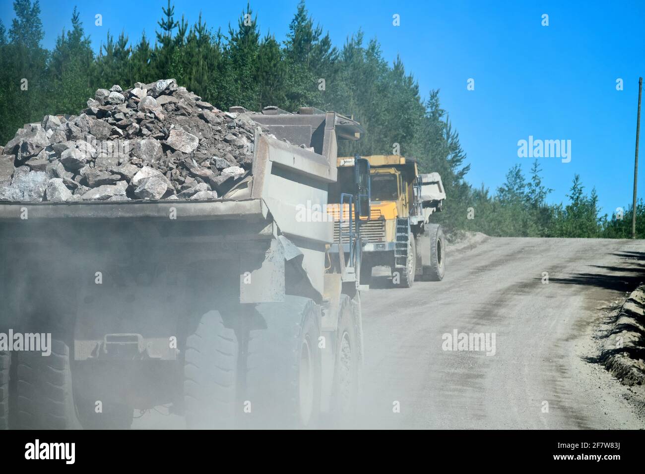 Open-pit operation. Pit dump truck, large-capacity dump truck rides on ...