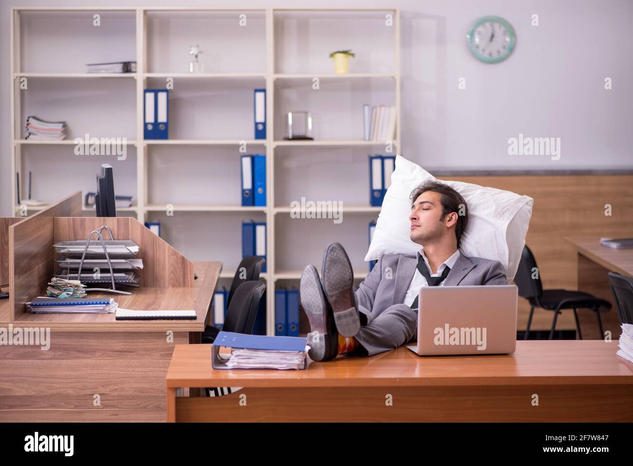 Young employee sleeping at workplace Stock Photo - Alamy