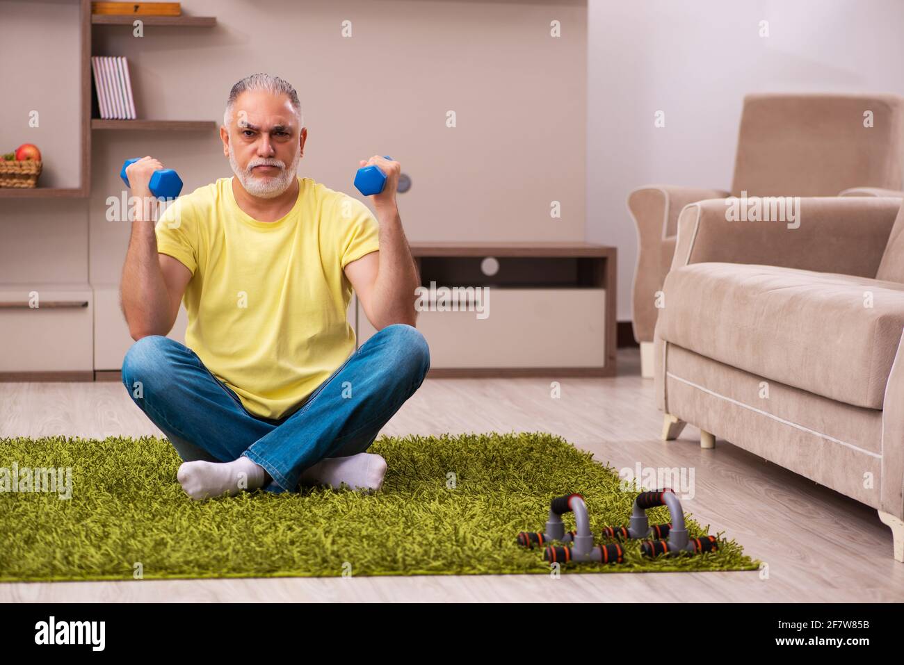 Old man doing sport exercises at home Stock Photo - Alamy