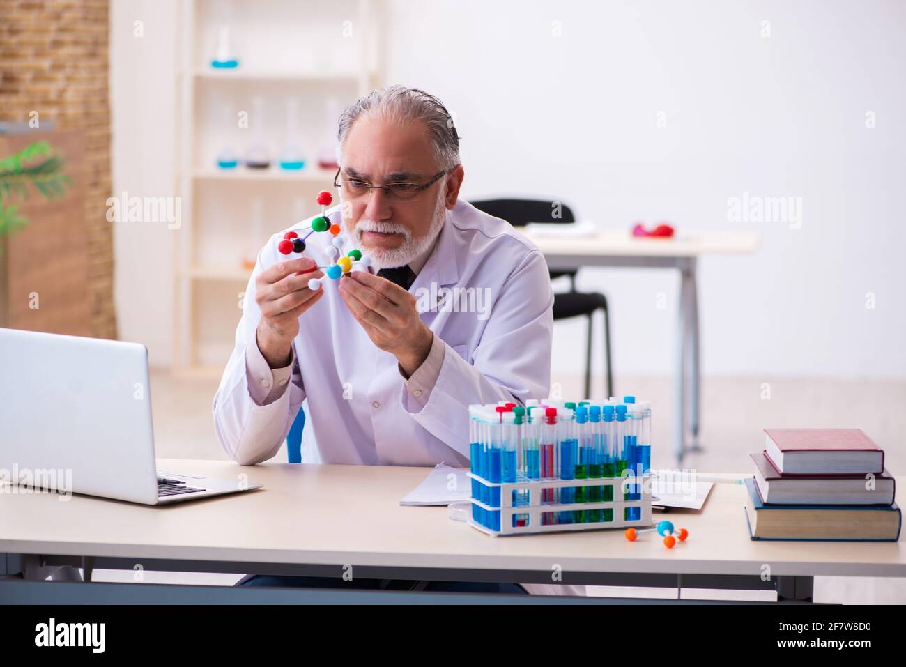 Senior male scientist studying molecular model Stock Photo - Alamy