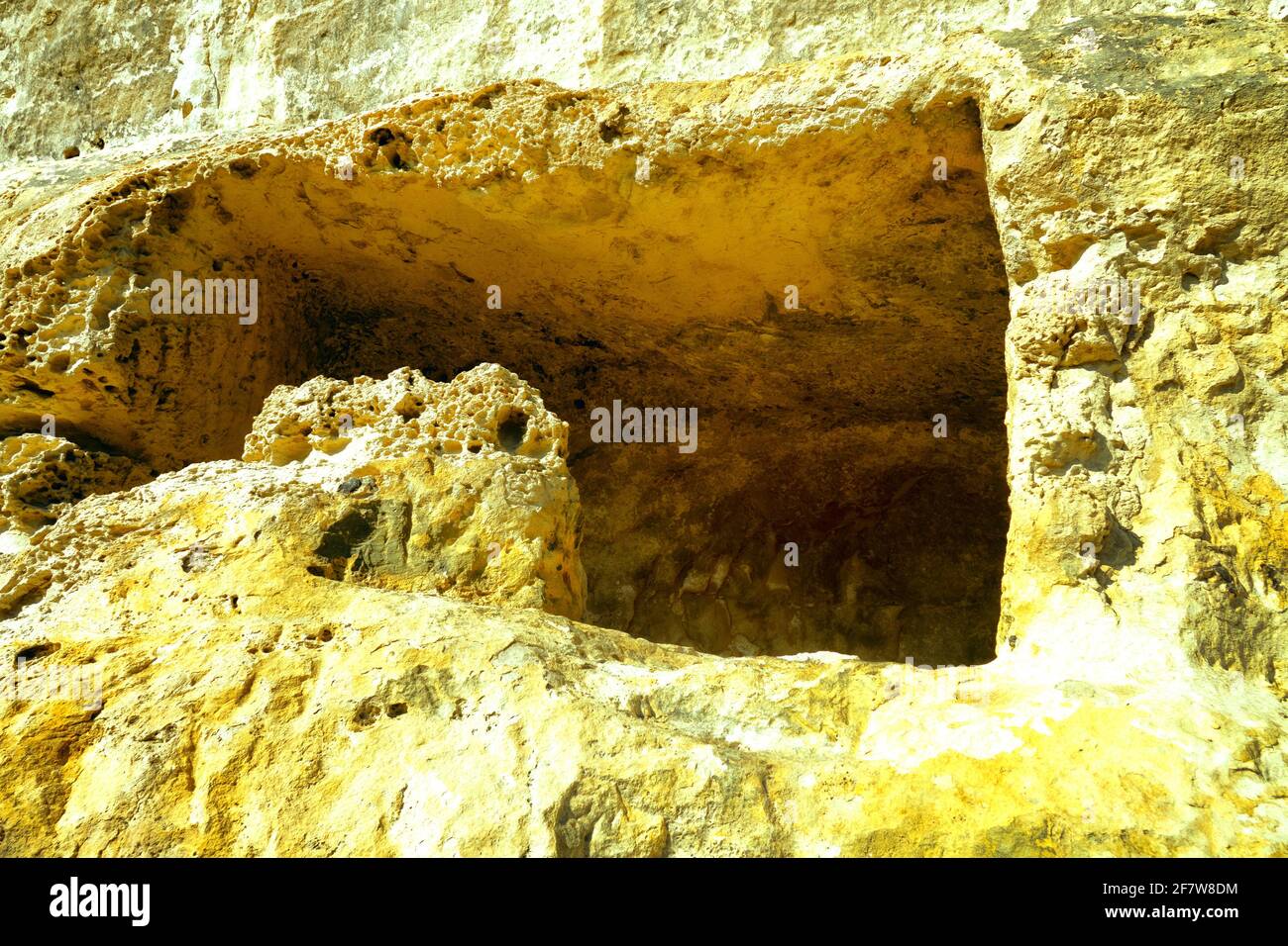 Entrance to a man-made cave in a limestone rock. A place of refuge for ...