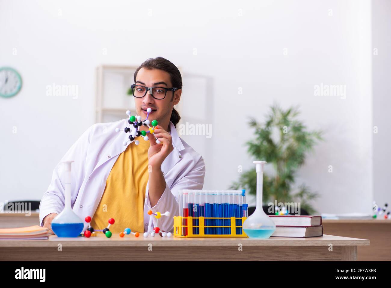 Young chemist studying molecular model in the classroom Stock Photo - Alamy