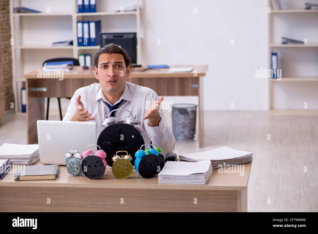 Young employee afraid of missing deadline at workplace Stock Photo - Alamy