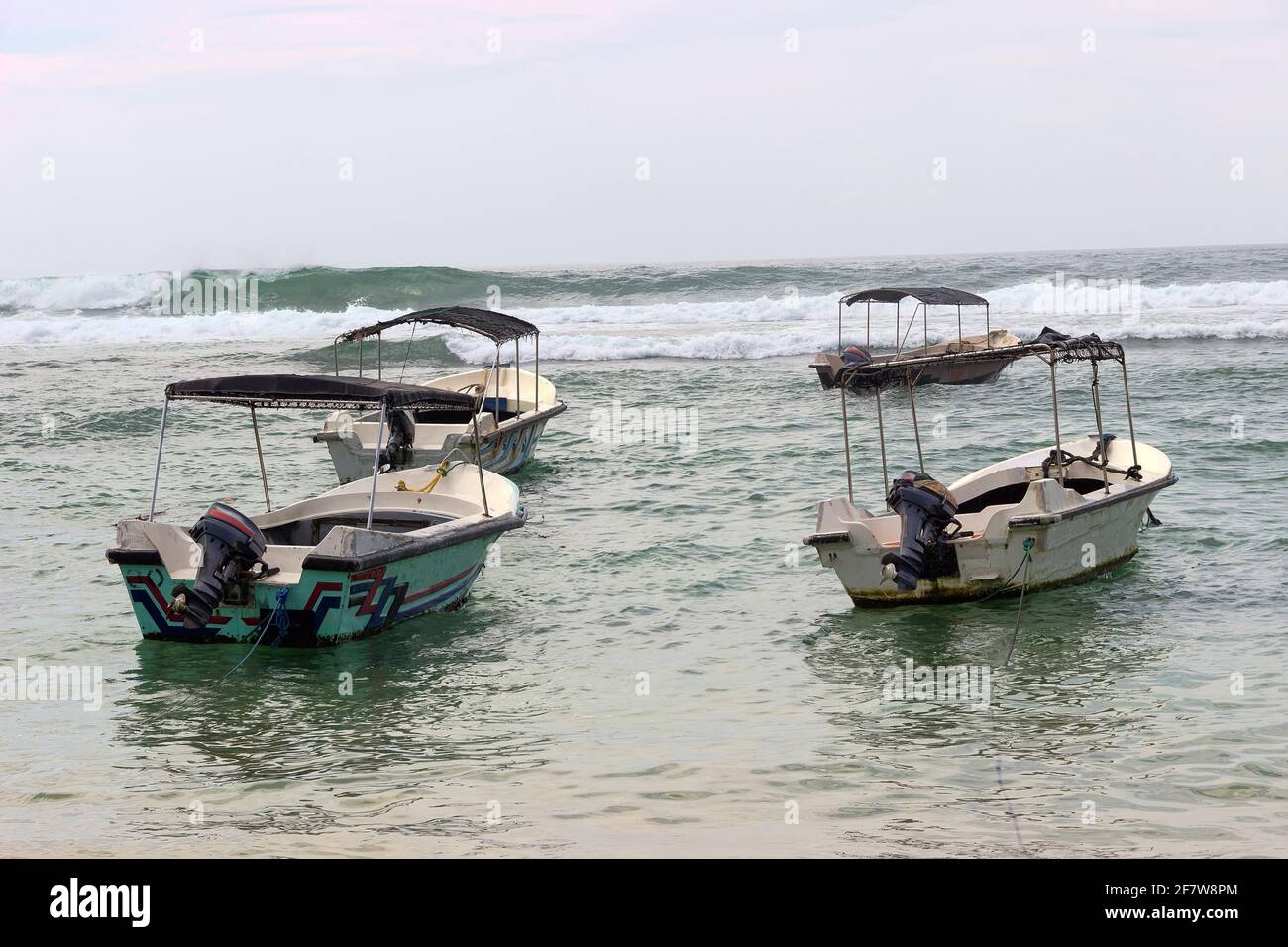 Water-based recreation. Pleasure boats on the beach in the surf and ...