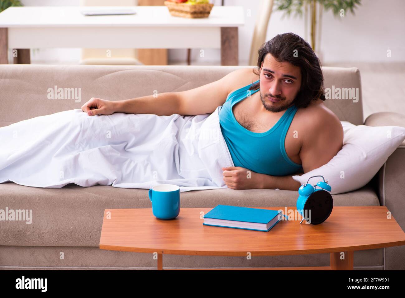 Man waking up on sofa hi-res stock photography and images - Alamy