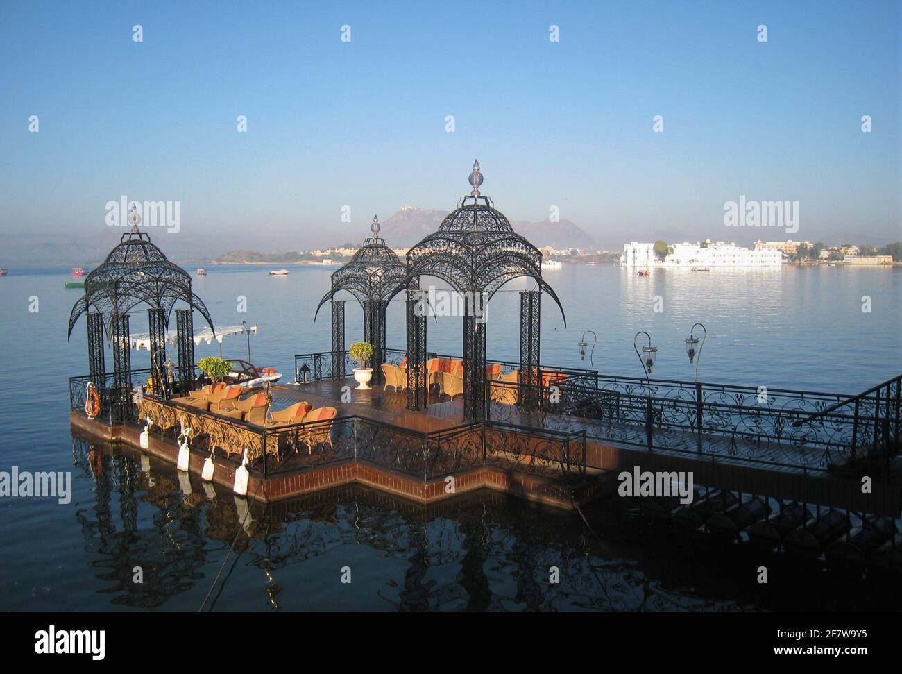 The beautiful Hotel Taj Lake Palace and the dock by the shore of the ...