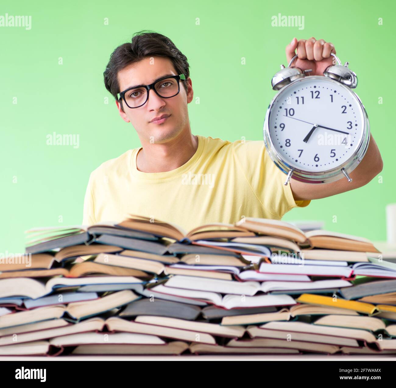 The student with too many books to read before exam Stock Photo - Alamy