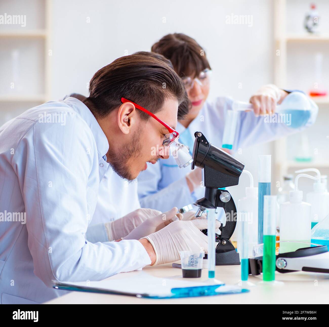 The team of chemists working in the lab Stock Photo - Alamy