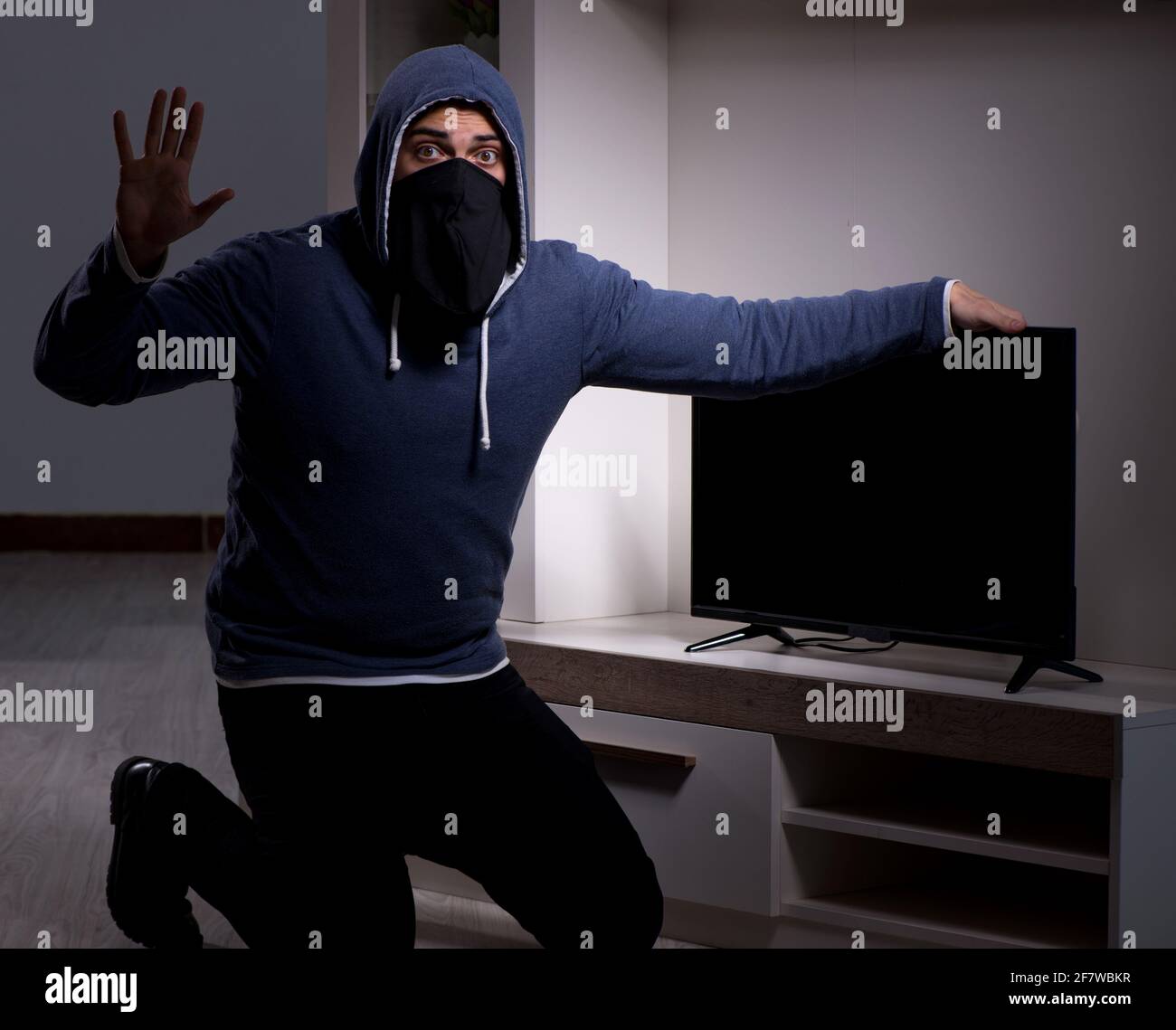 The burglar thief stealing tv from apartment house Stock Photo - Alamy