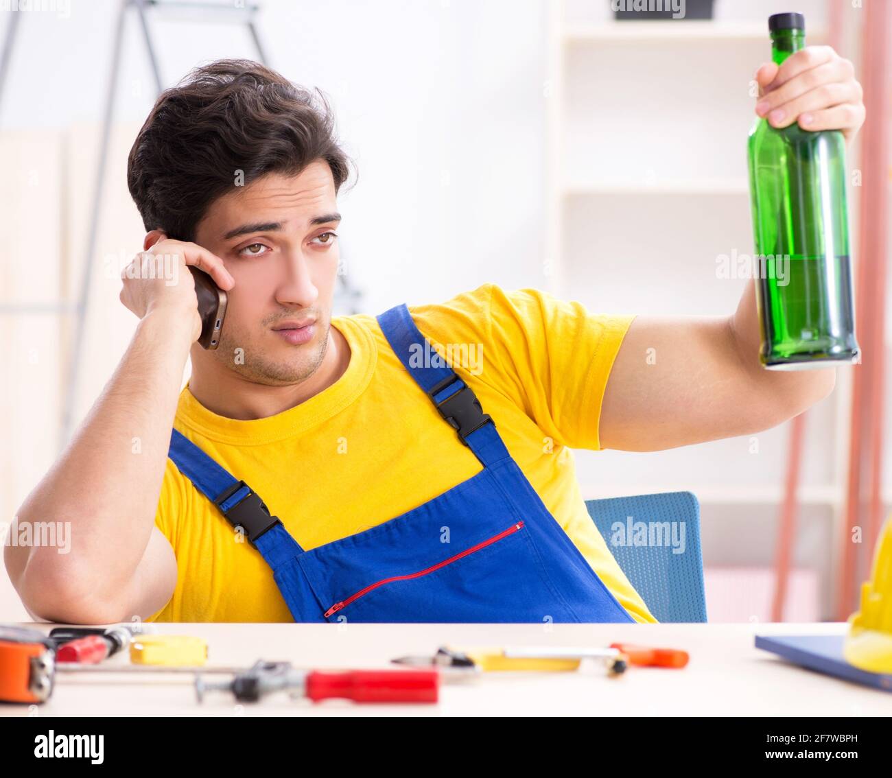 The drunk engineer working in the workshop Stock Photo - Alamy