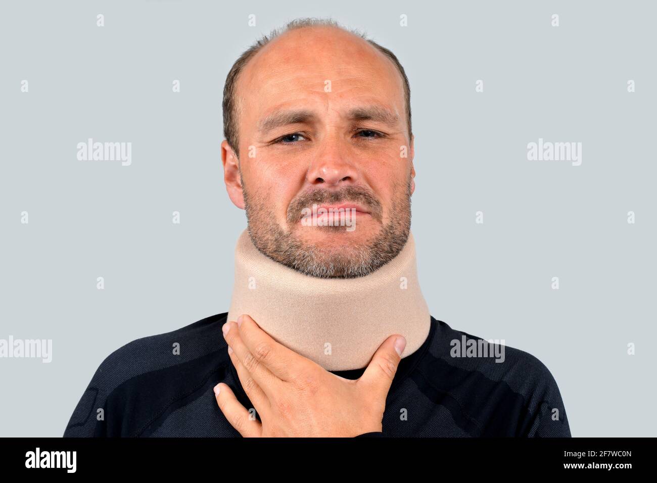 The man wearing neck collar on gray background. Concept neck injury ...