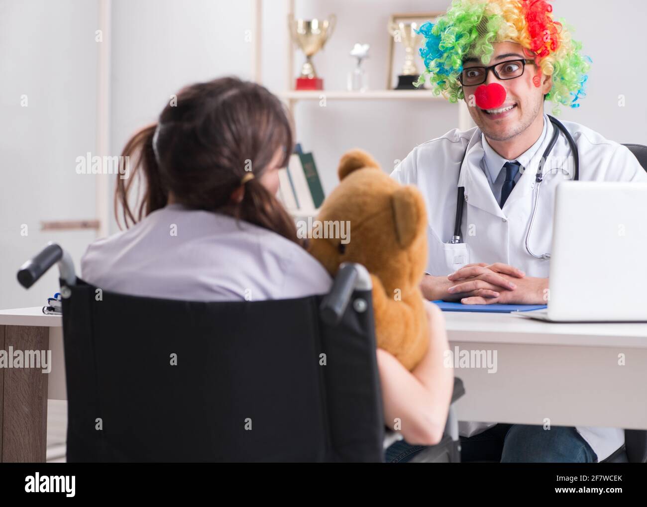 The funny pediatrician with little girl at regular check-up Stock Photo ...
