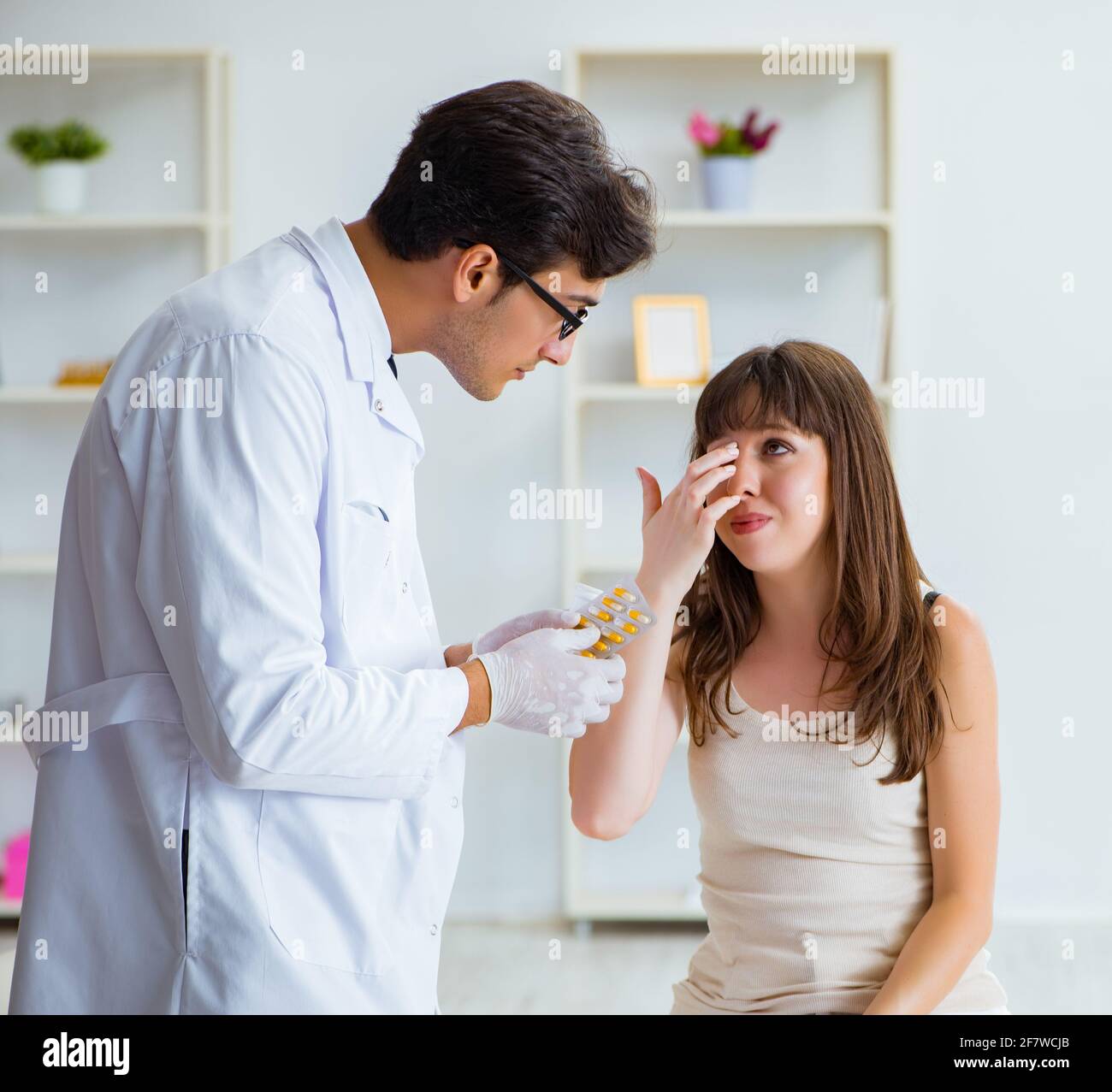 The doctor examining the skin of female patient Stock Photo - Alamy