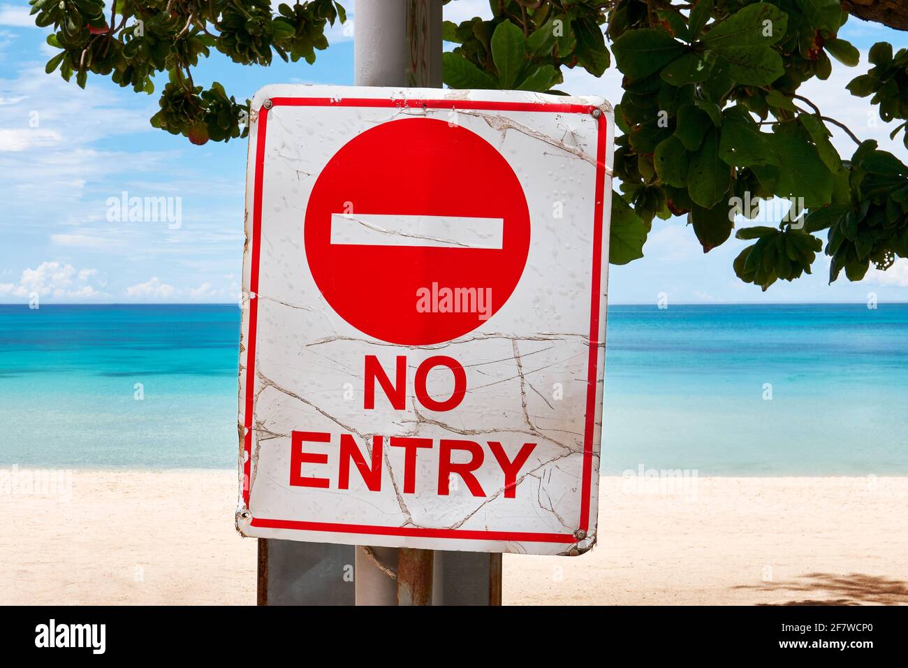 Red colored no entry road sign attached to a pole in front of the White ...