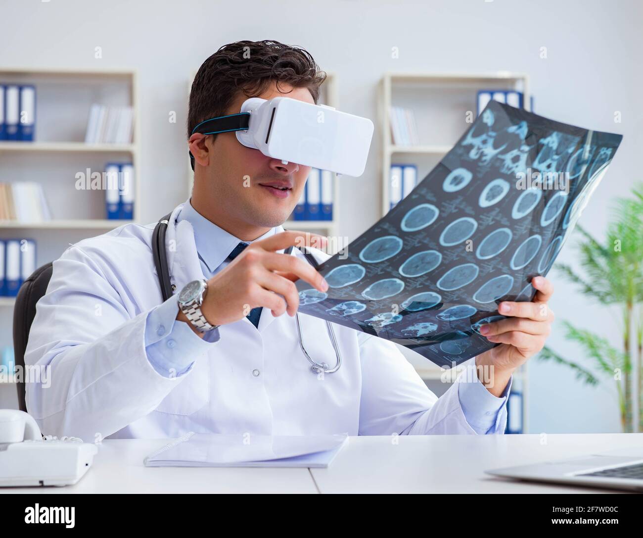 The young doctor looking at mri scan through vr glasses Stock Photo - Alamy