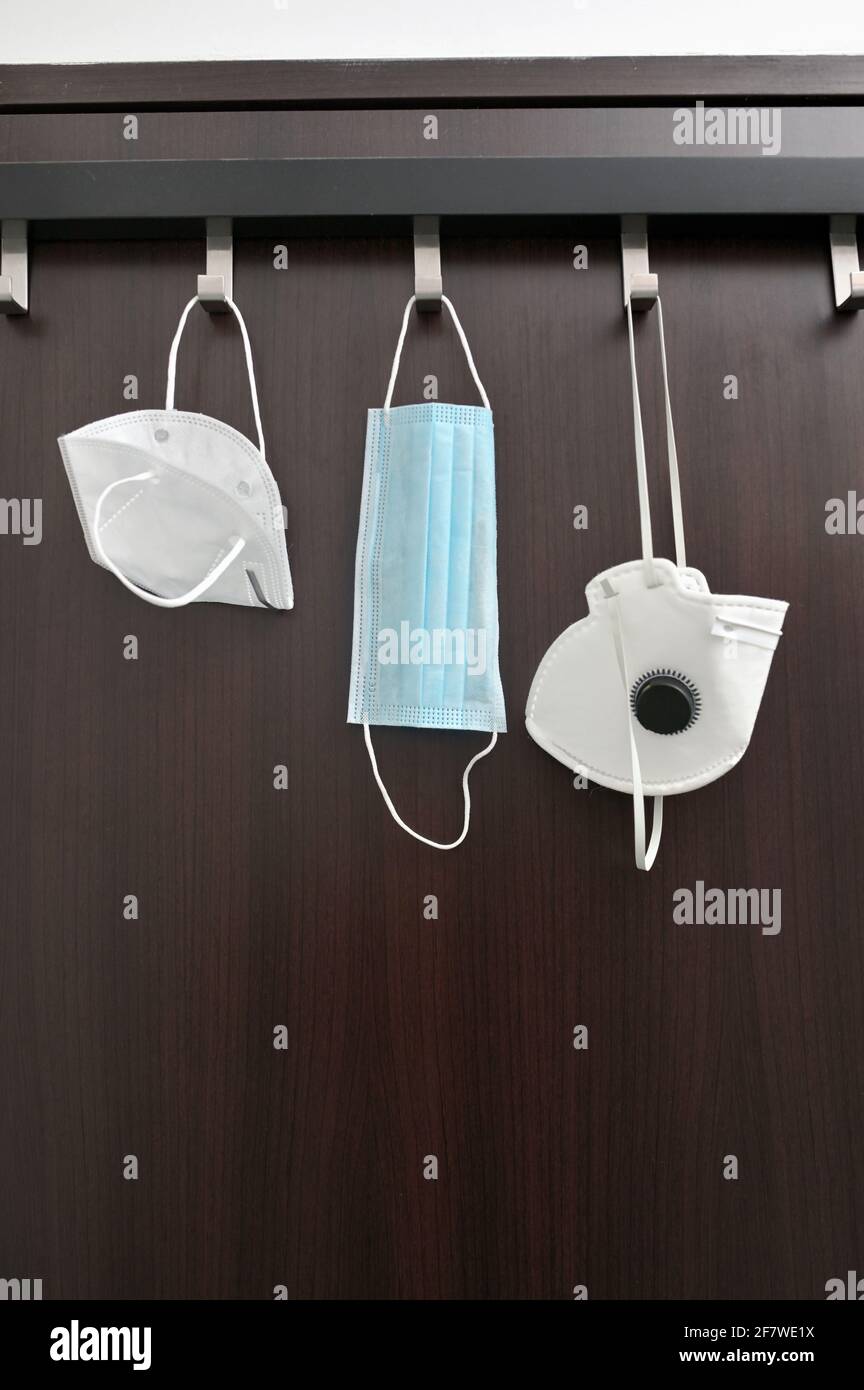 Conceptual Types of Medical Masks Hanging on Hanger Stock Photo - Alamy
