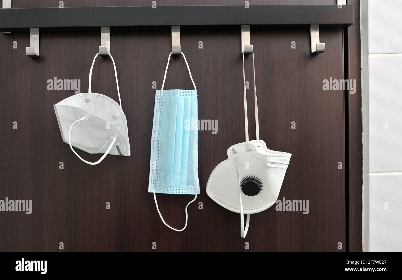 Conceptual Types of Medical Masks Hanging on Hanger Stock Photo - Alamy