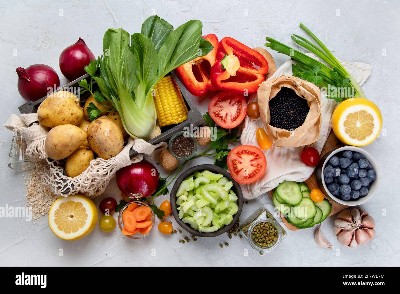 Selection of fresh raw vegetables, fruits and beans on light gray ...