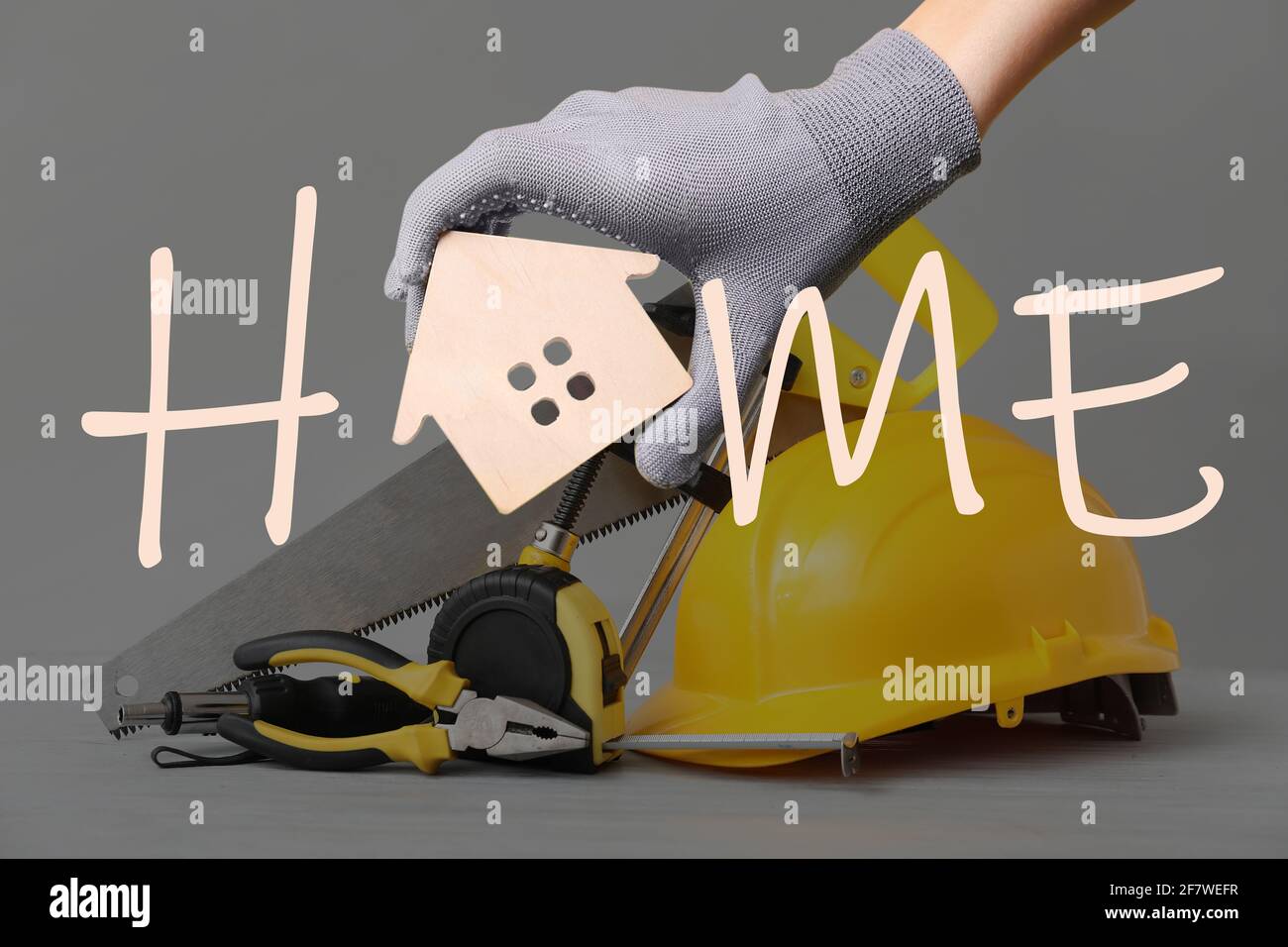 Collage of construction tools with word HOME and builder's hand with ...