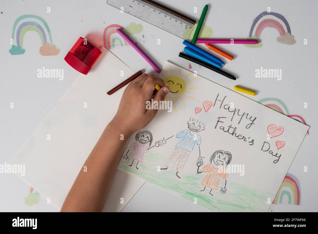 Detail shot of the hands of two girls making by hand some drawings and ...