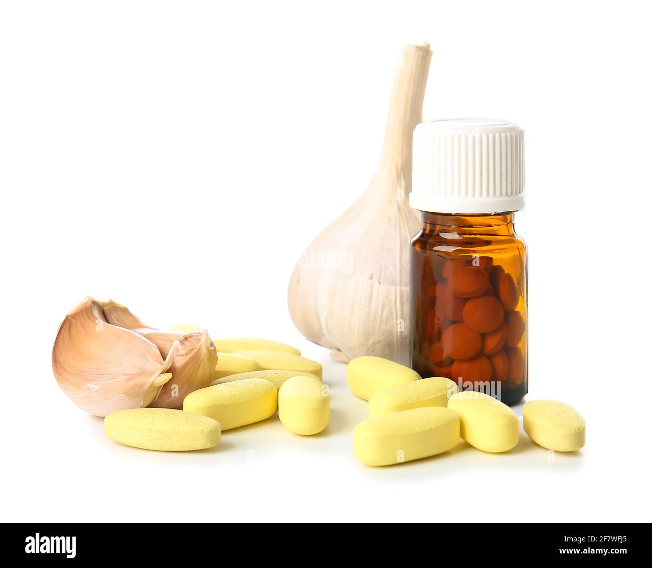 Fresh garlic with pills on white background Stock Photo - Alamy