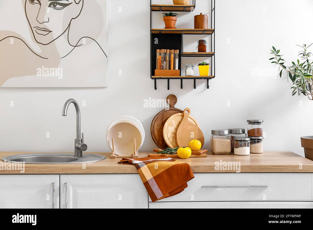 Counter with products and utensils in interior of modern kitchen Stock ...