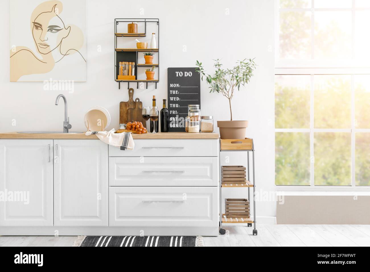 Counter with products and utensils in interior of modern kitchen Stock ...
