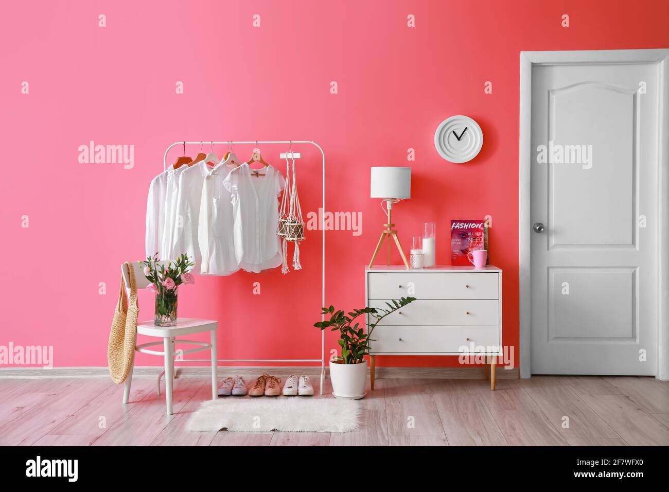 Rack with clothes in interior of modern room Stock Photo - Alamy