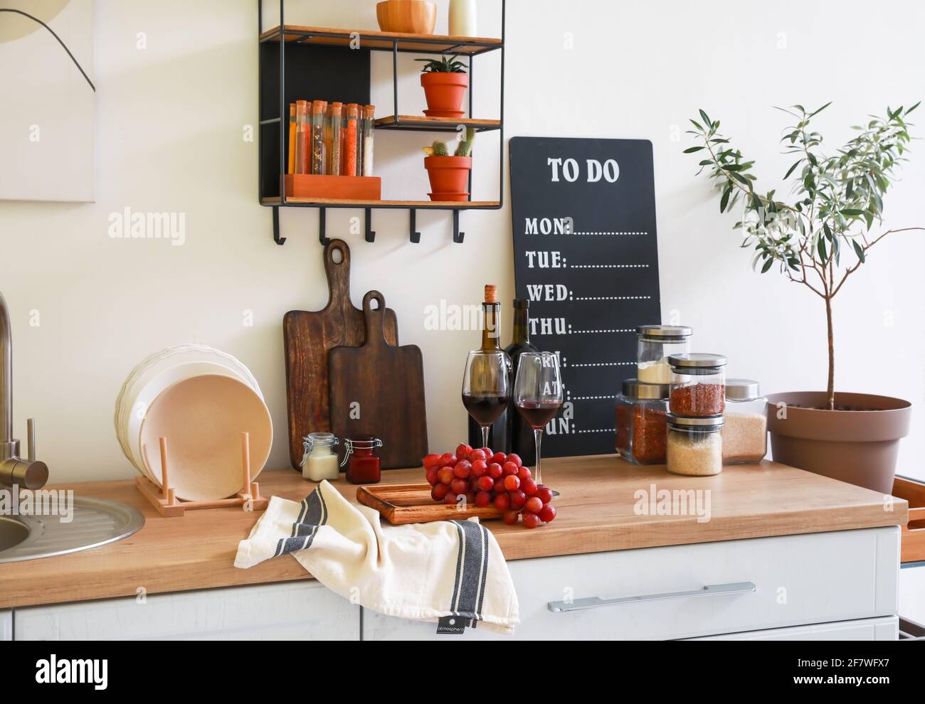 Counter with products and utensils in interior of modern kitchen Stock ...