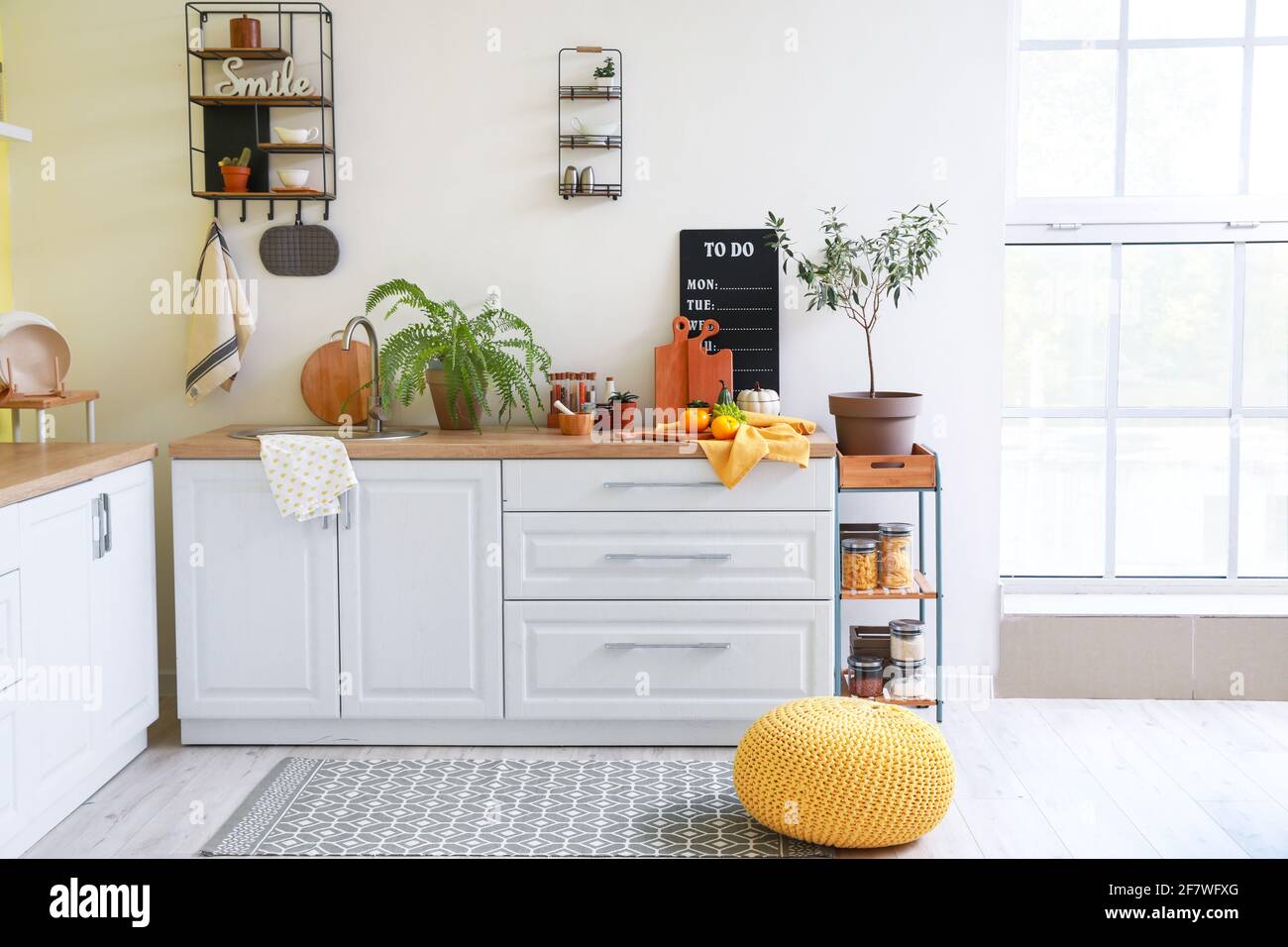 Counter with products and utensils in interior of modern kitchen Stock ...