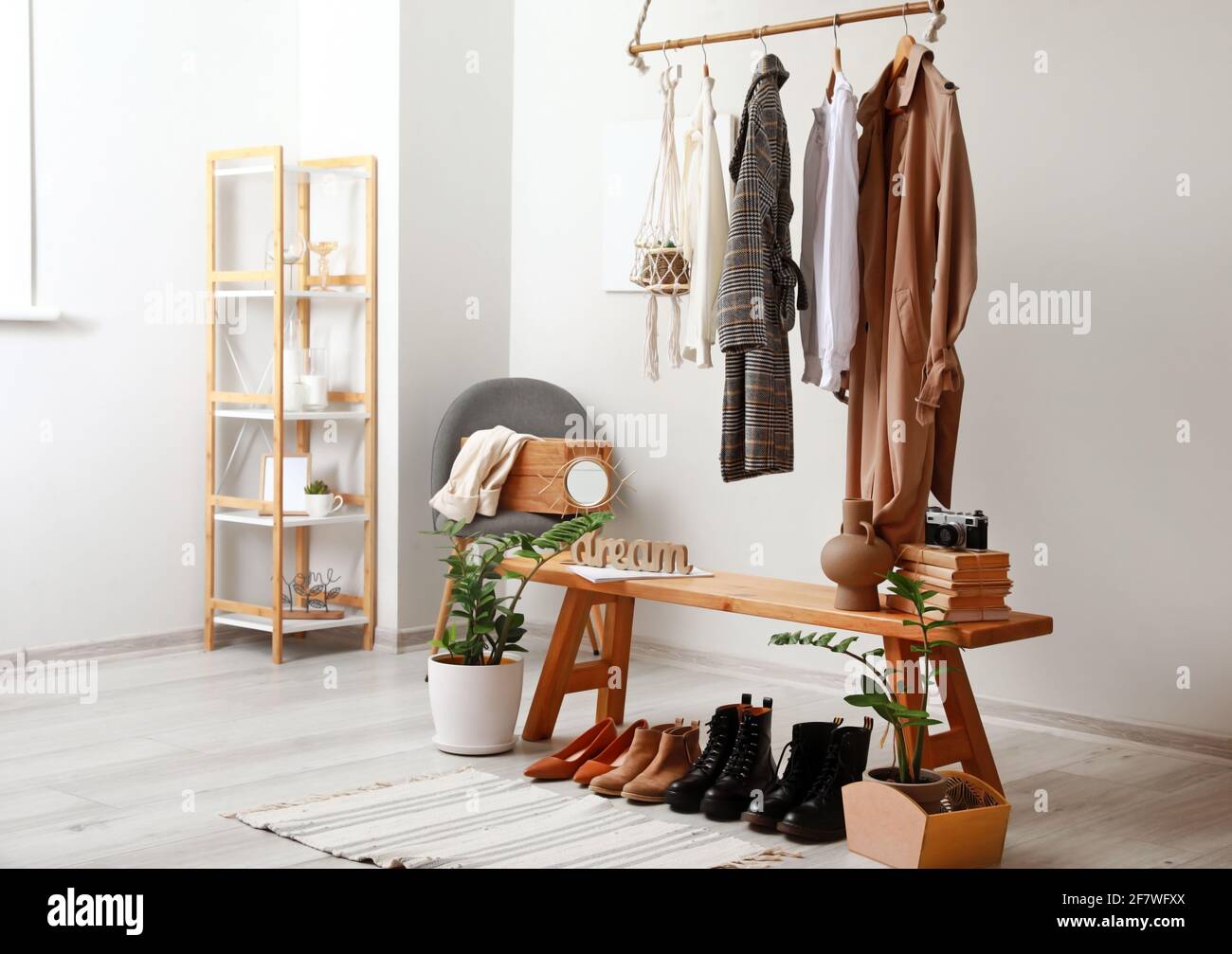 Rack with clothes in interior of modern room Stock Photo - Alamy