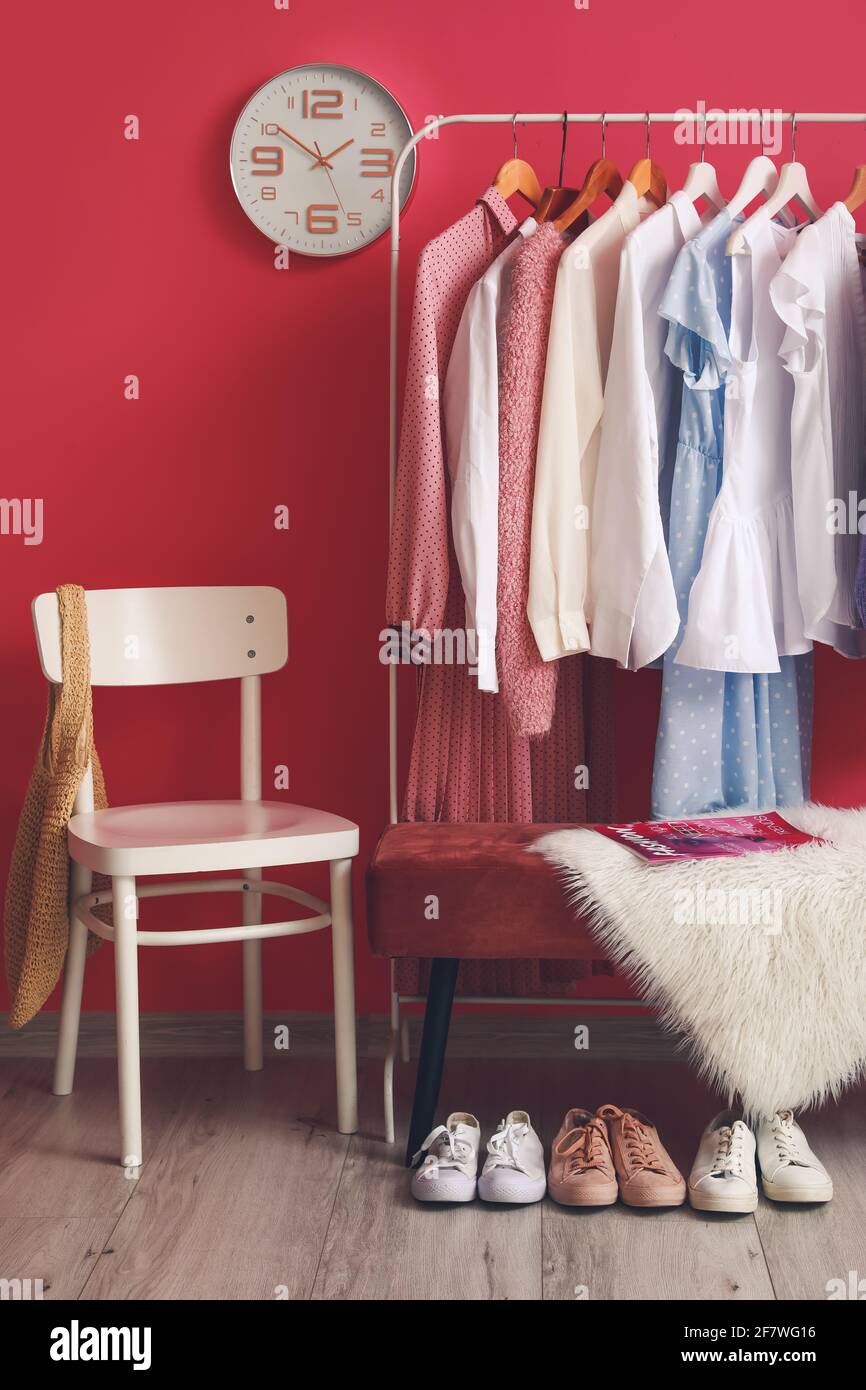 Rack with clothes in interior of modern room Stock Photo - Alamy