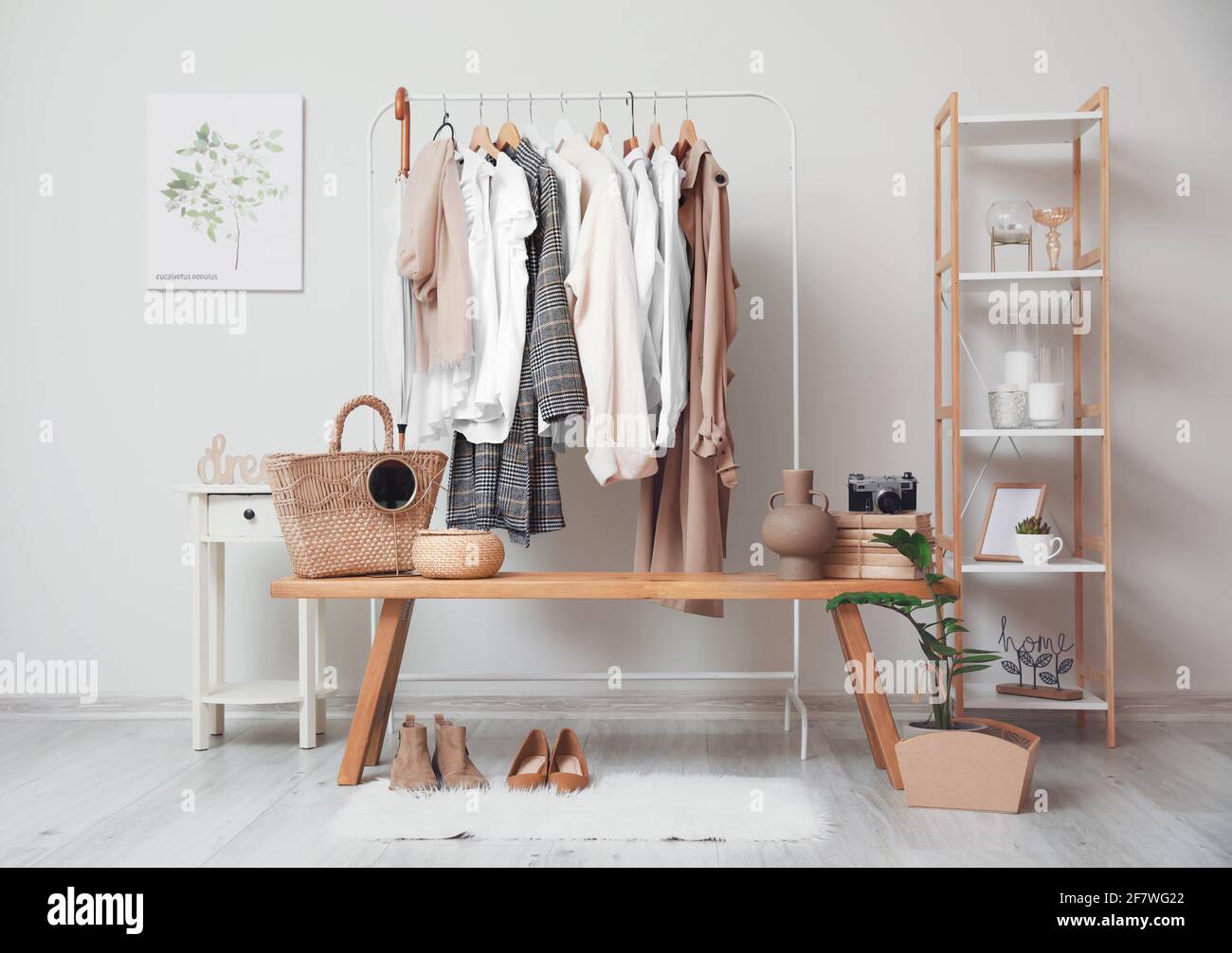Rack with clothes in interior of modern room Stock Photo - Alamy