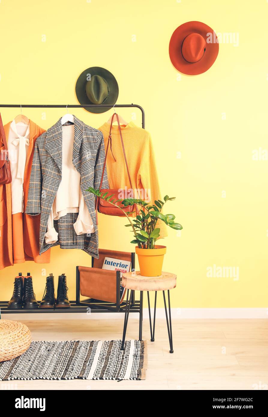 Rack with clothes in interior of modern room Stock Photo - Alamy