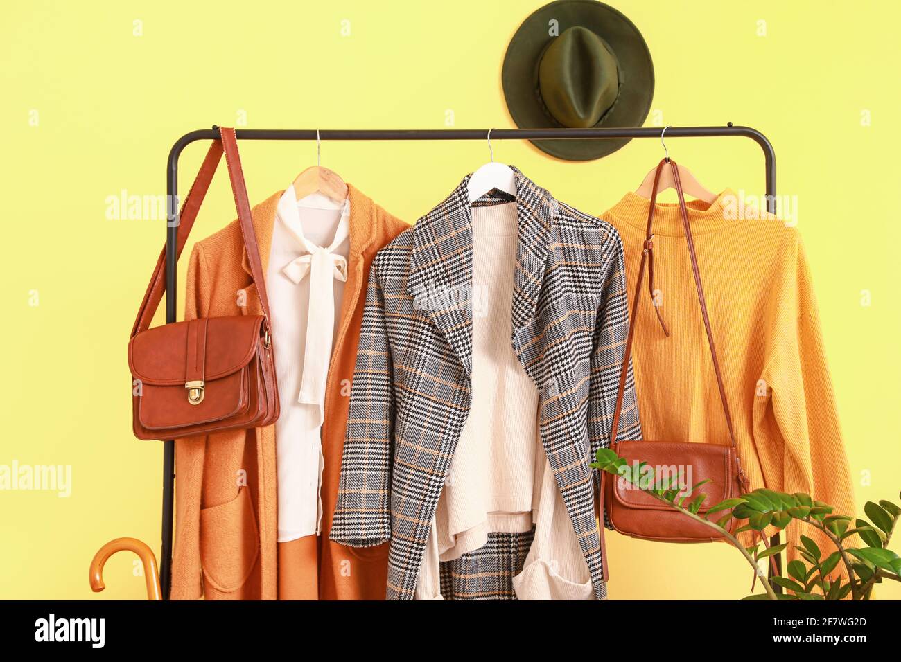 Rack with modern clothes in room Stock Photo - Alamy
