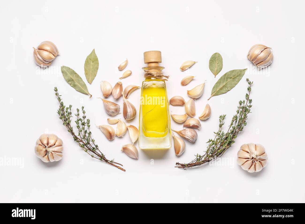 Composition with bottle of garlic oil on white background Stock Photo ...