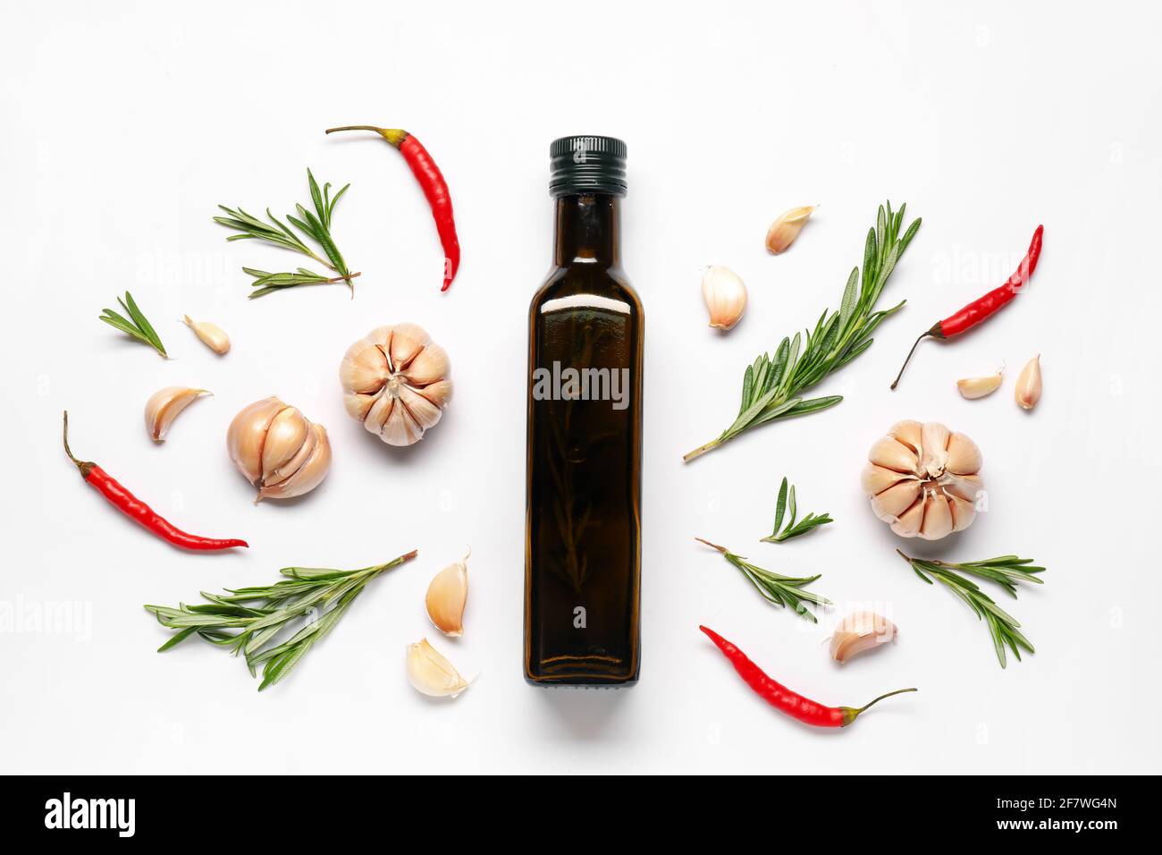 Composition with bottle of garlic oil on white background Stock Photo ...
