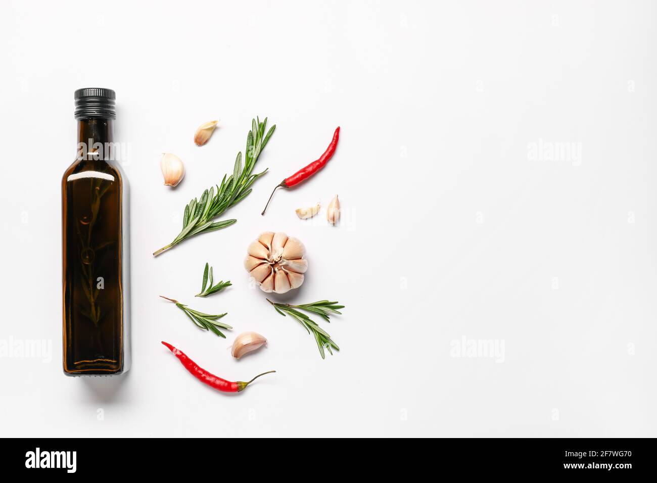 Composition with bottle of garlic oil on white background Stock Photo ...