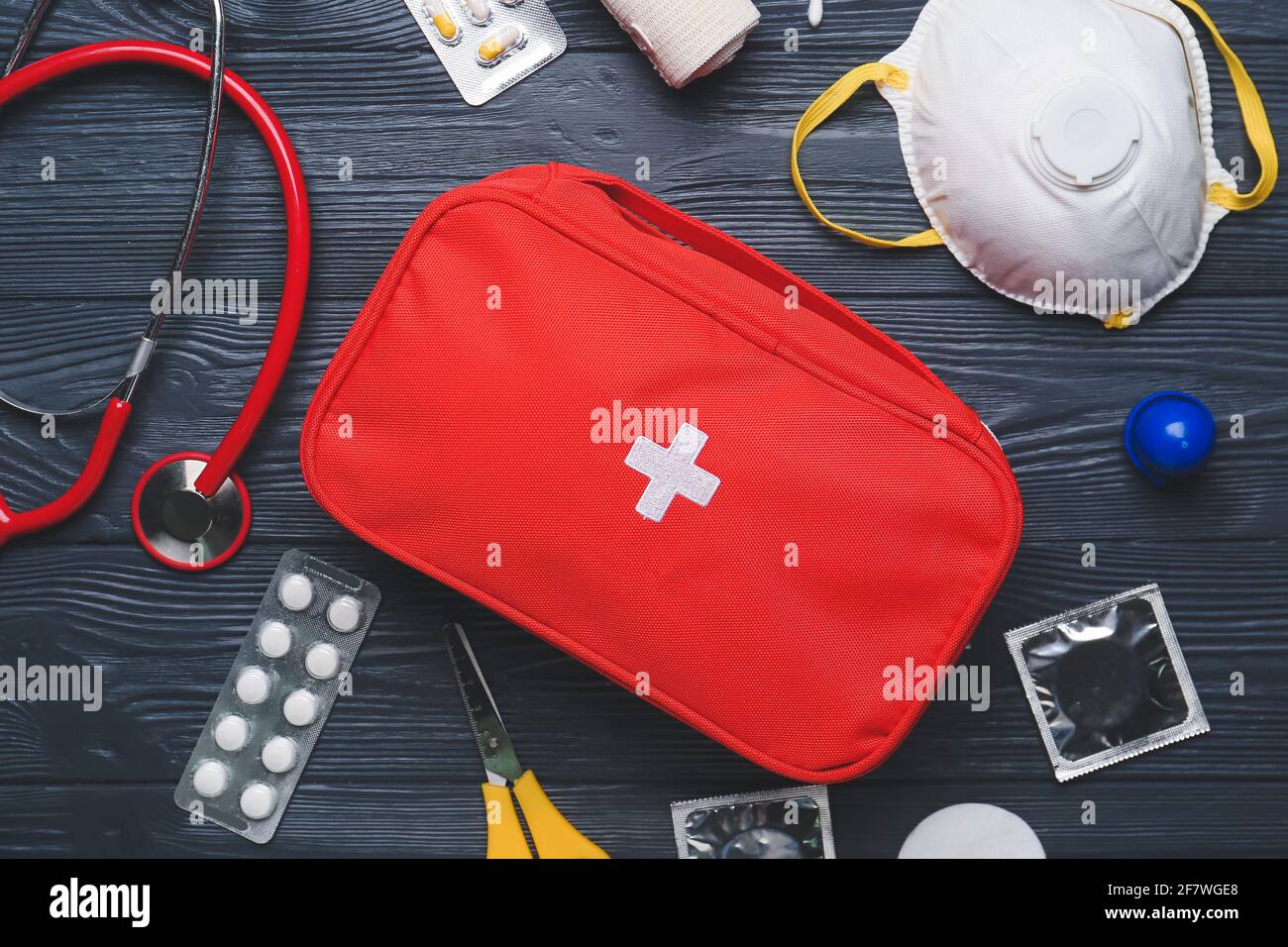 First aid kit on dark wooden background Stock Photo - Alamy