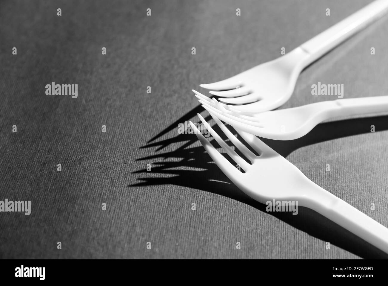 Plastic fork on dark background Stock Photo - Alamy